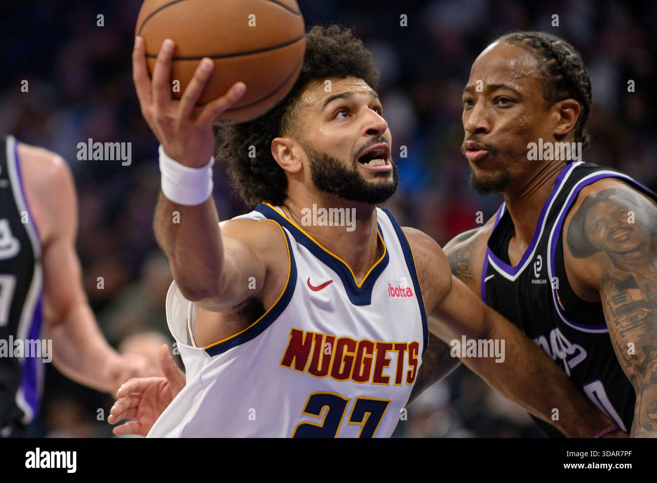 Denver Nuggets guard Jamal Murray, left, drives past Sacramento Kings ...