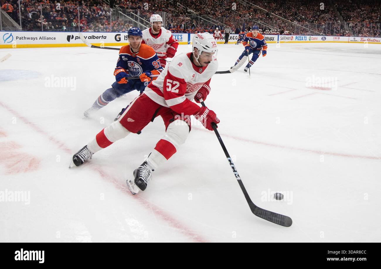 Detroit Red Wings' Travis Hamonic (52) is chased by Edmonton Oilers ...
