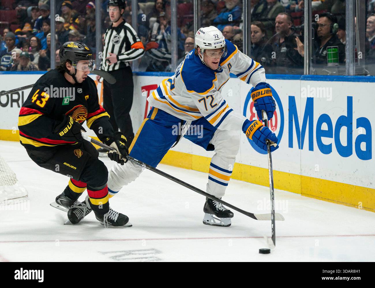 Buffalo Sabres' Tage Thompson, right, tries to fight off the check of ...