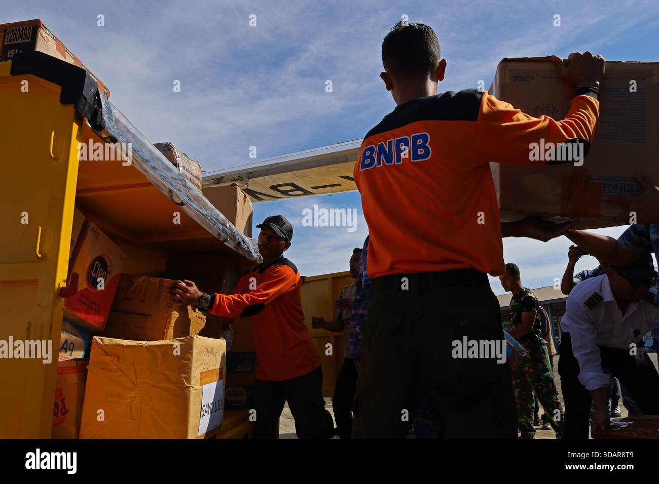 December 11, 2025, Aceh Besar, Aceh, Indonesia: Officers load disaster ...