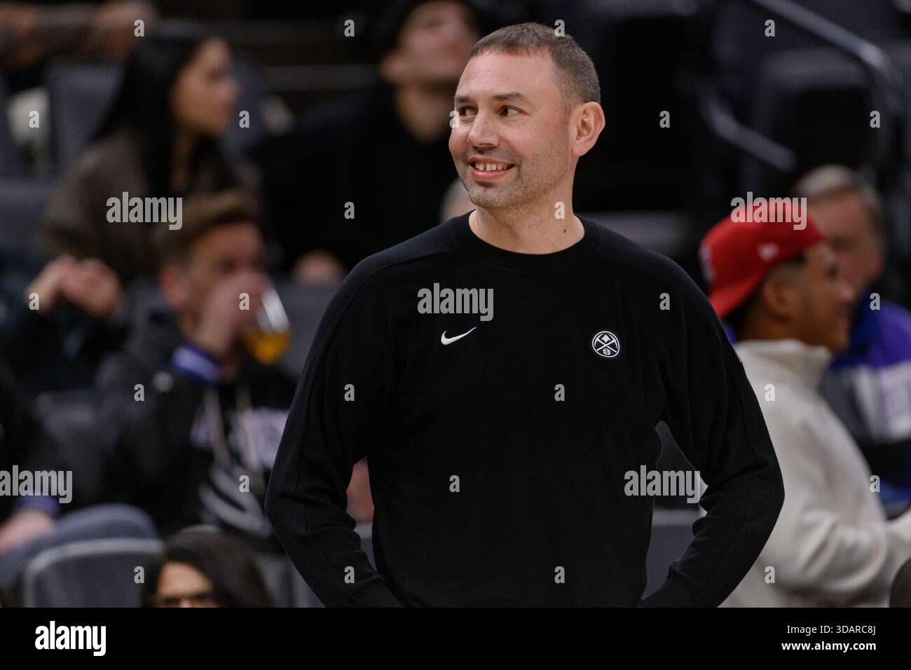 Denver Nuggets head coach David Adelman smiles at his bench during the ...
