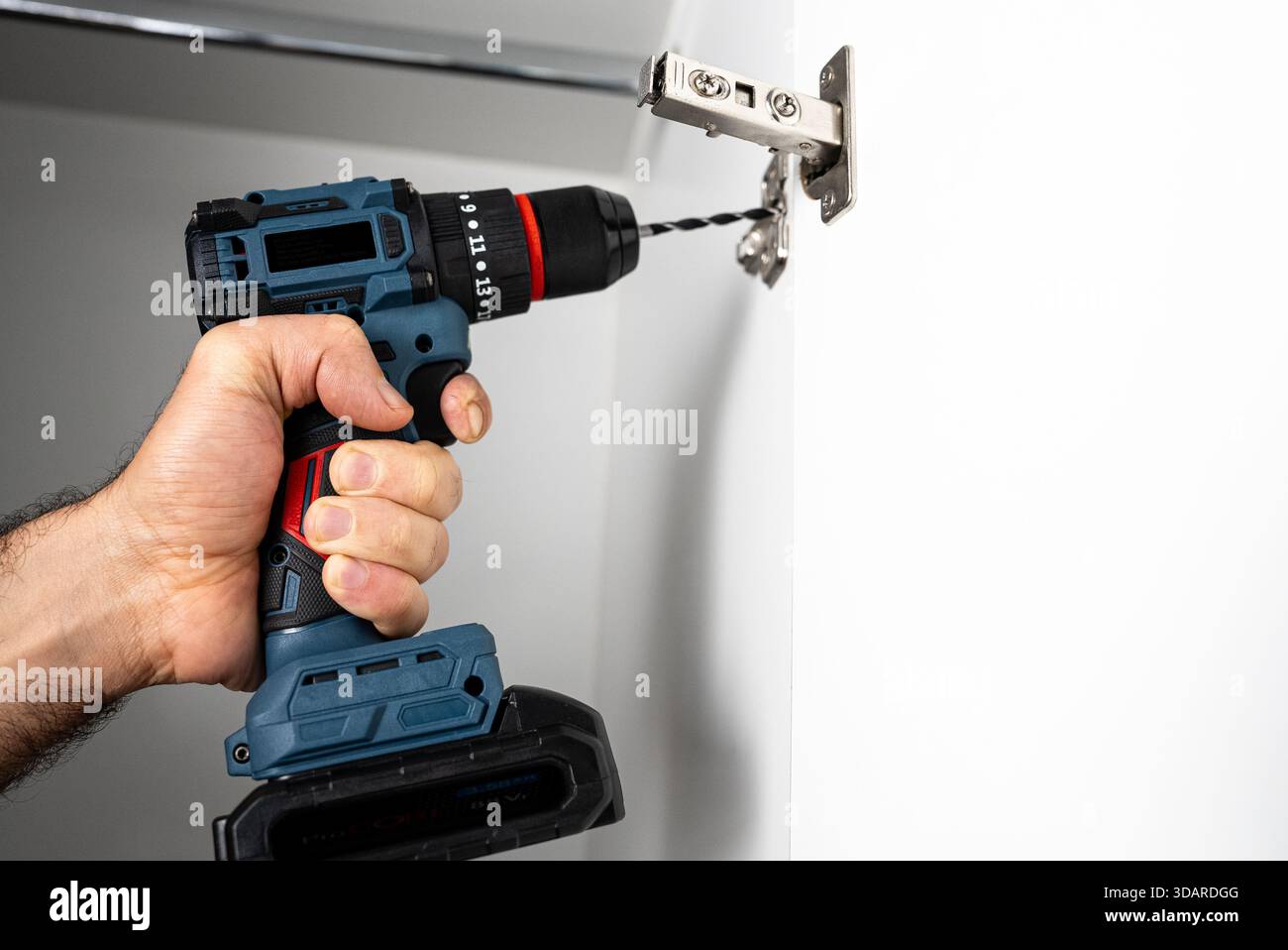 Person uses cordless drill secure hi-res stock photography and images ...