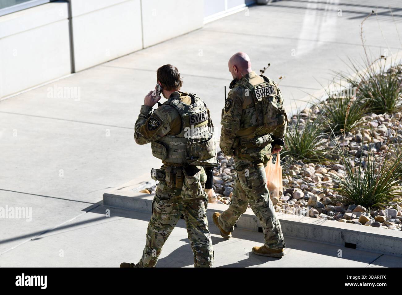 December 11, 2025, Provo, Utah, USA: Two SWAT members walk near the ...