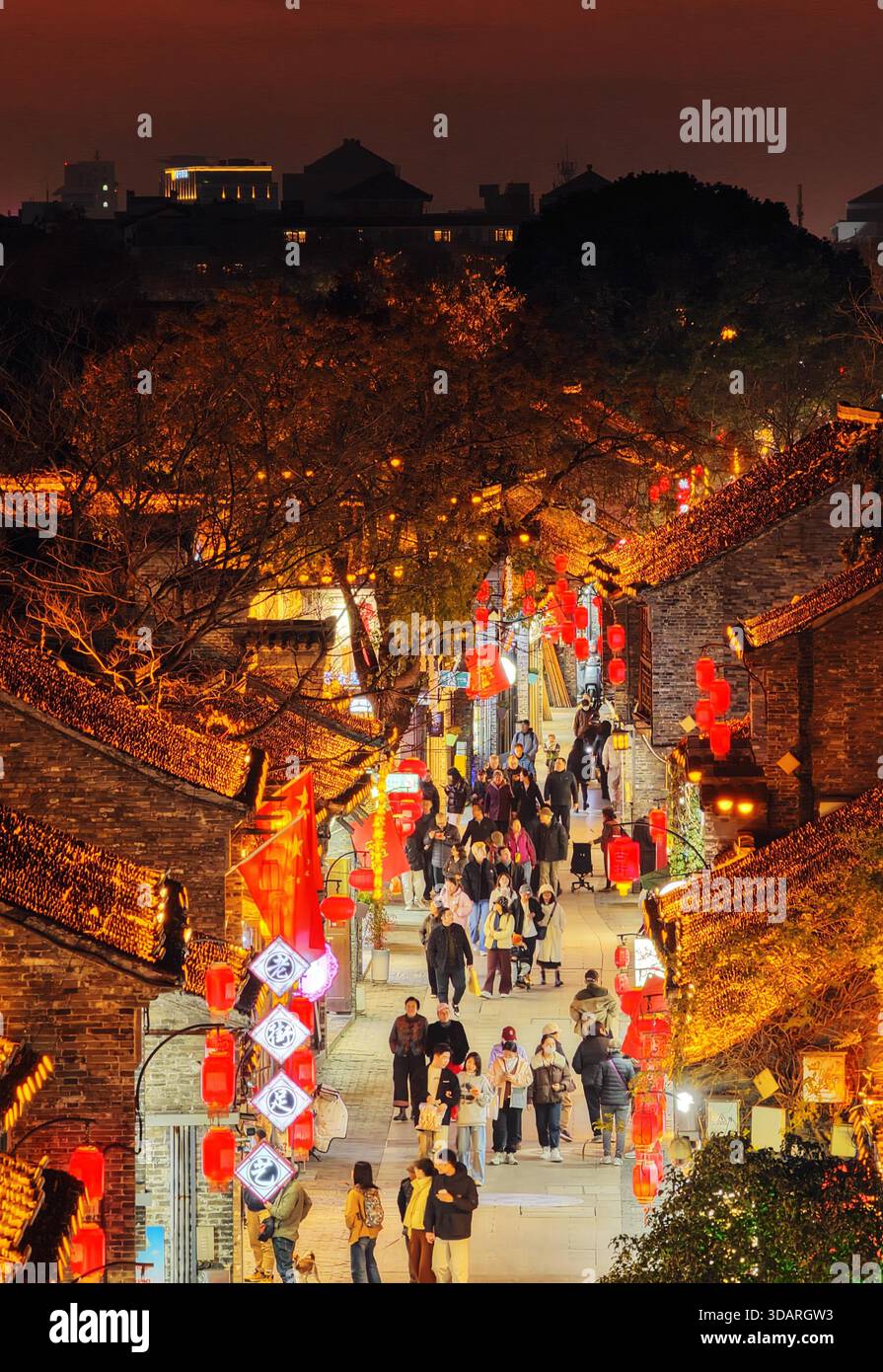 Aerial photo shows tourists strolling in Dongguan Street at night in ...