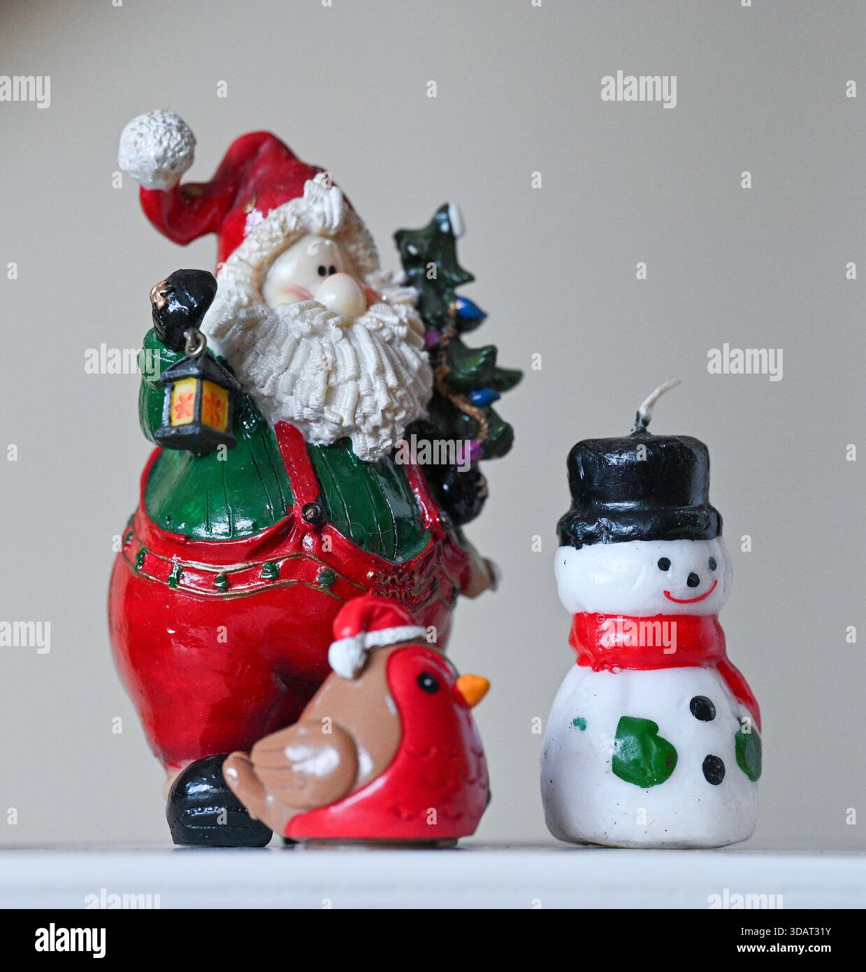 Traditional retro Christmas decorations including a snowman candle ...