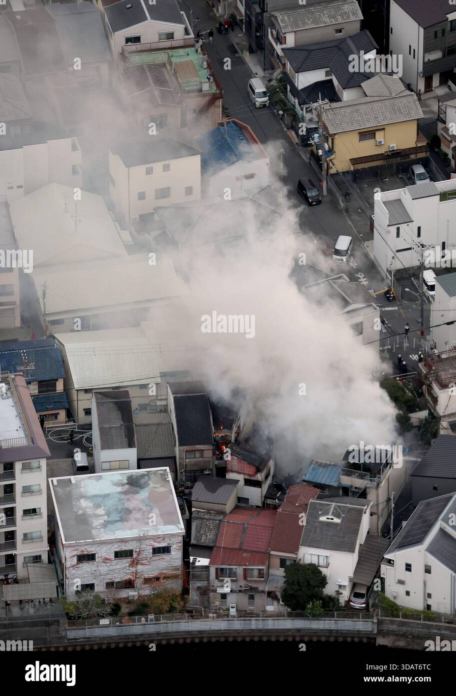 An aerial photo shows the scene of a fire spreading from a house in ...