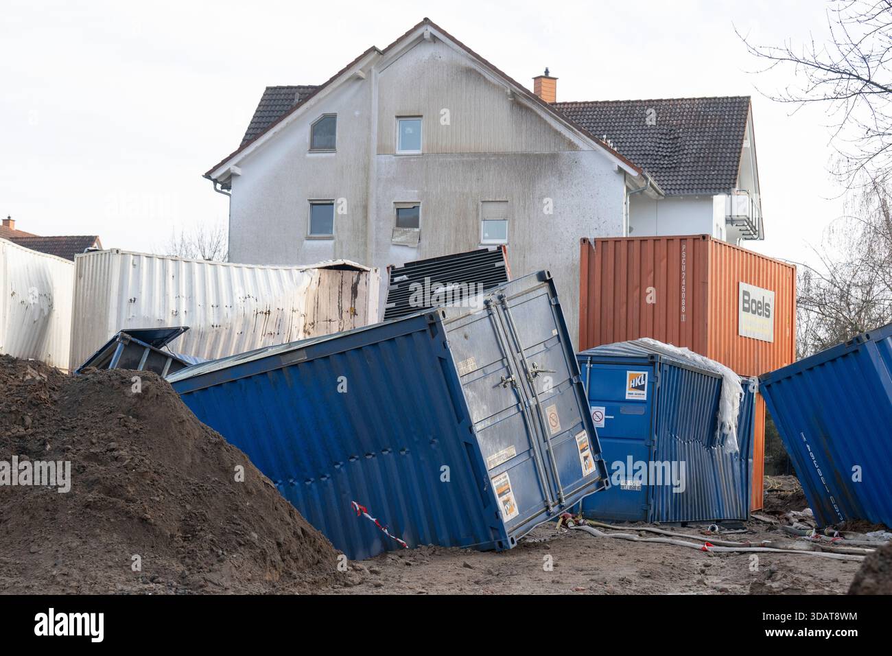 12 December 2025, Hesse, Hanau: Damaged overseas containers lie in ...