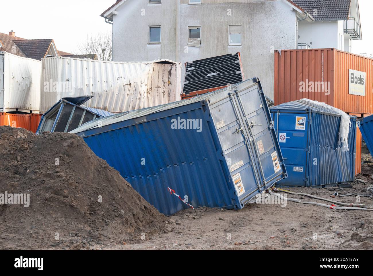 12 December 2025, Hesse, Hanau: Damaged overseas containers lie in ...