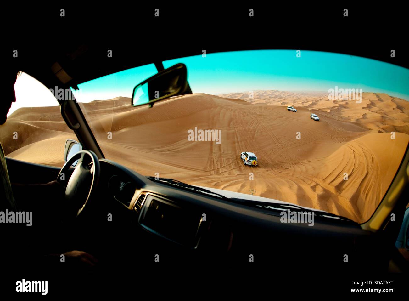 Wide angle view of a professional driver dune bashing in the Empty ...