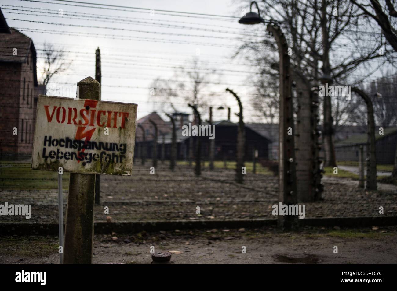 A sign with inscription reading (German) "Caution! High voltage, danger ...