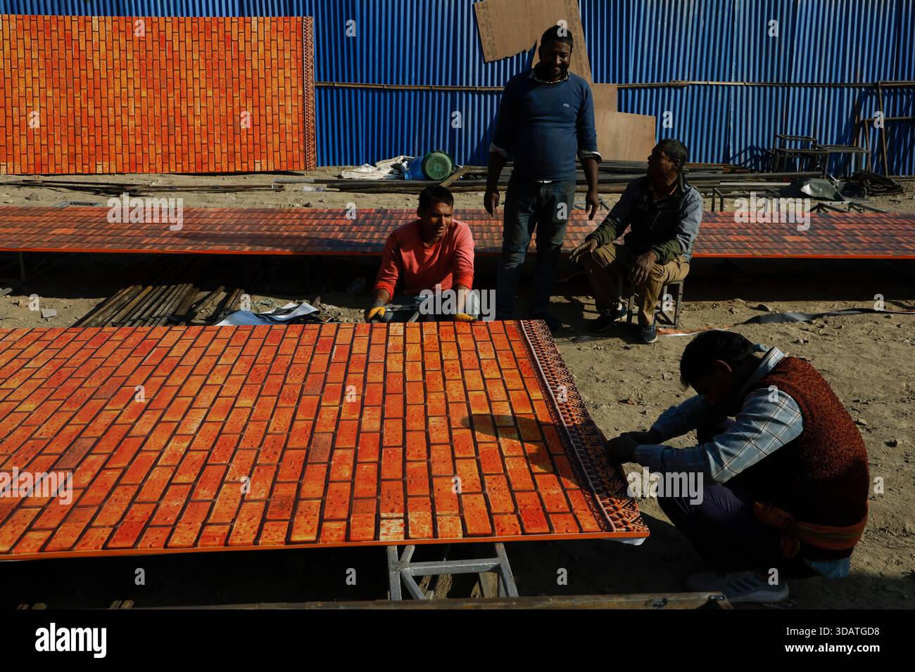 On December 12, 2025, in Bhaktapur, Nepal. Workers work on a hoarding ...