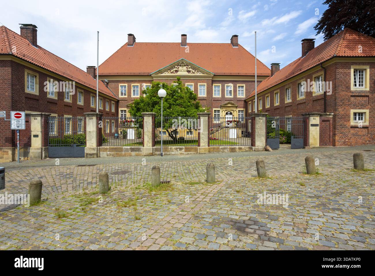 View of the Bischoeflicher Hof, a red-brick building with a vibrant ...