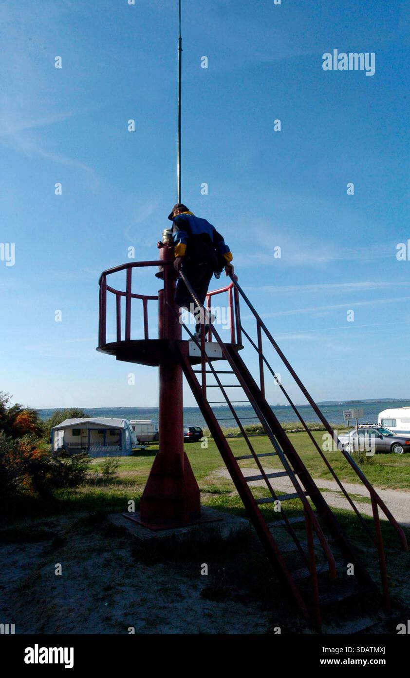 a lighthouse as a navigational aid in shipping traffic and transport ...