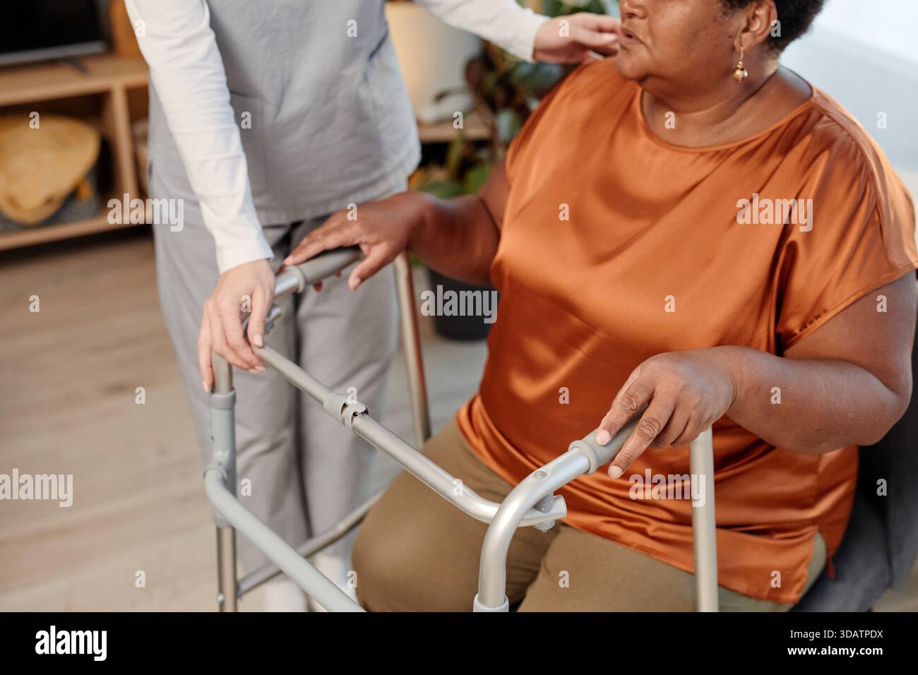 Senior Black Woman Receiving Assistance from Caregiver Using Walker ...