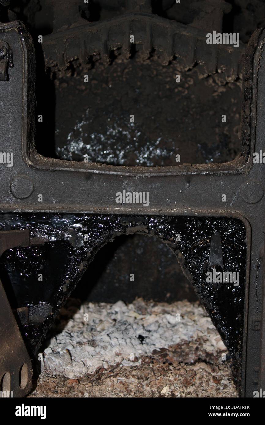 The cast iron stove shows a view of soot and ash after cooking with ...