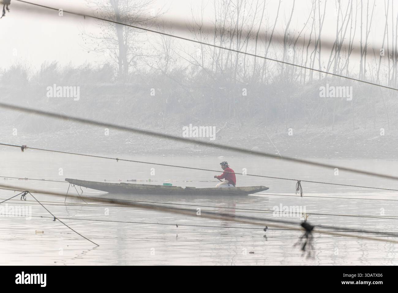 December 12, 2025, Pulwama, Jammu And Kashmir, India: A man rows a boat ...