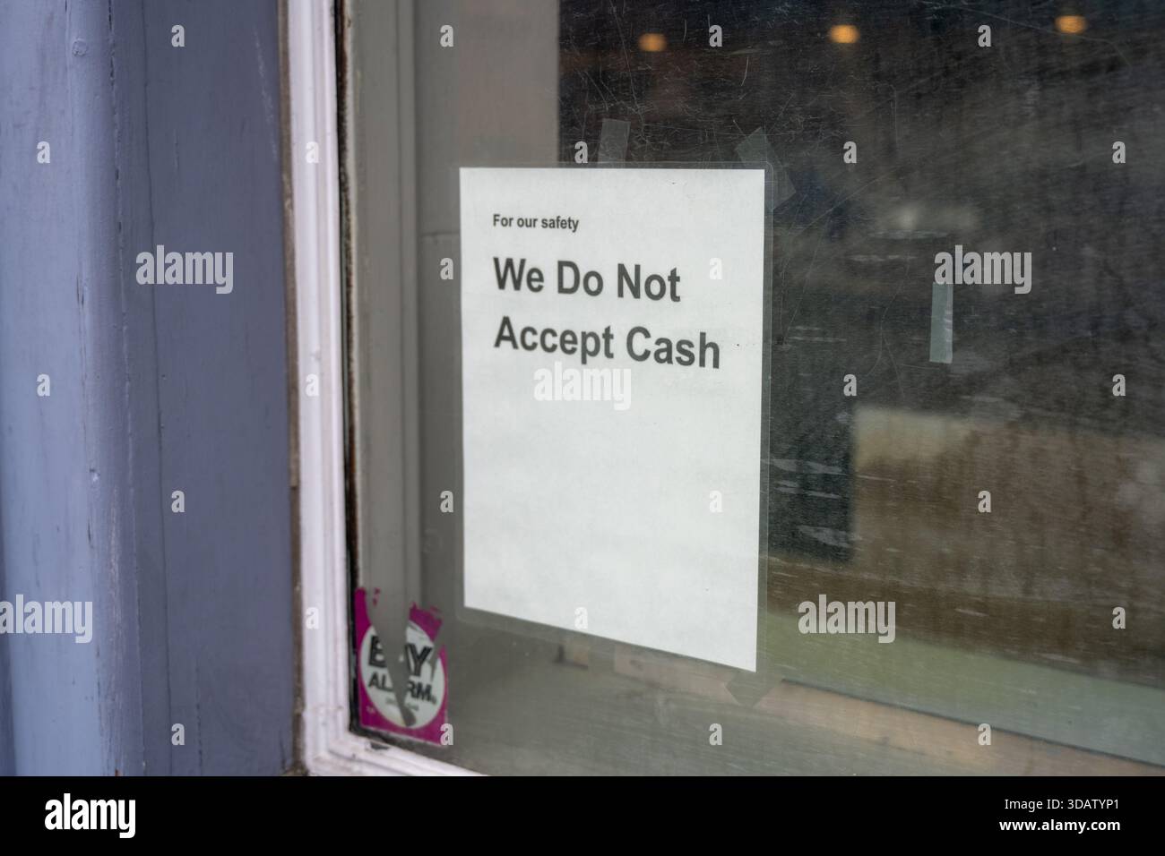 Sign on storefront reading For Our Safety We Do Not Accept Cash ...