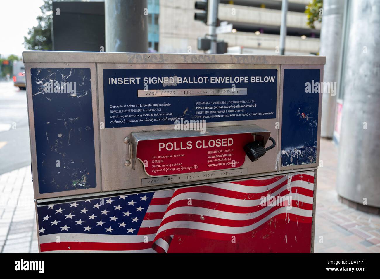 Close-up of ballot drop box with "Polls Closed" notice, padlock, and ...