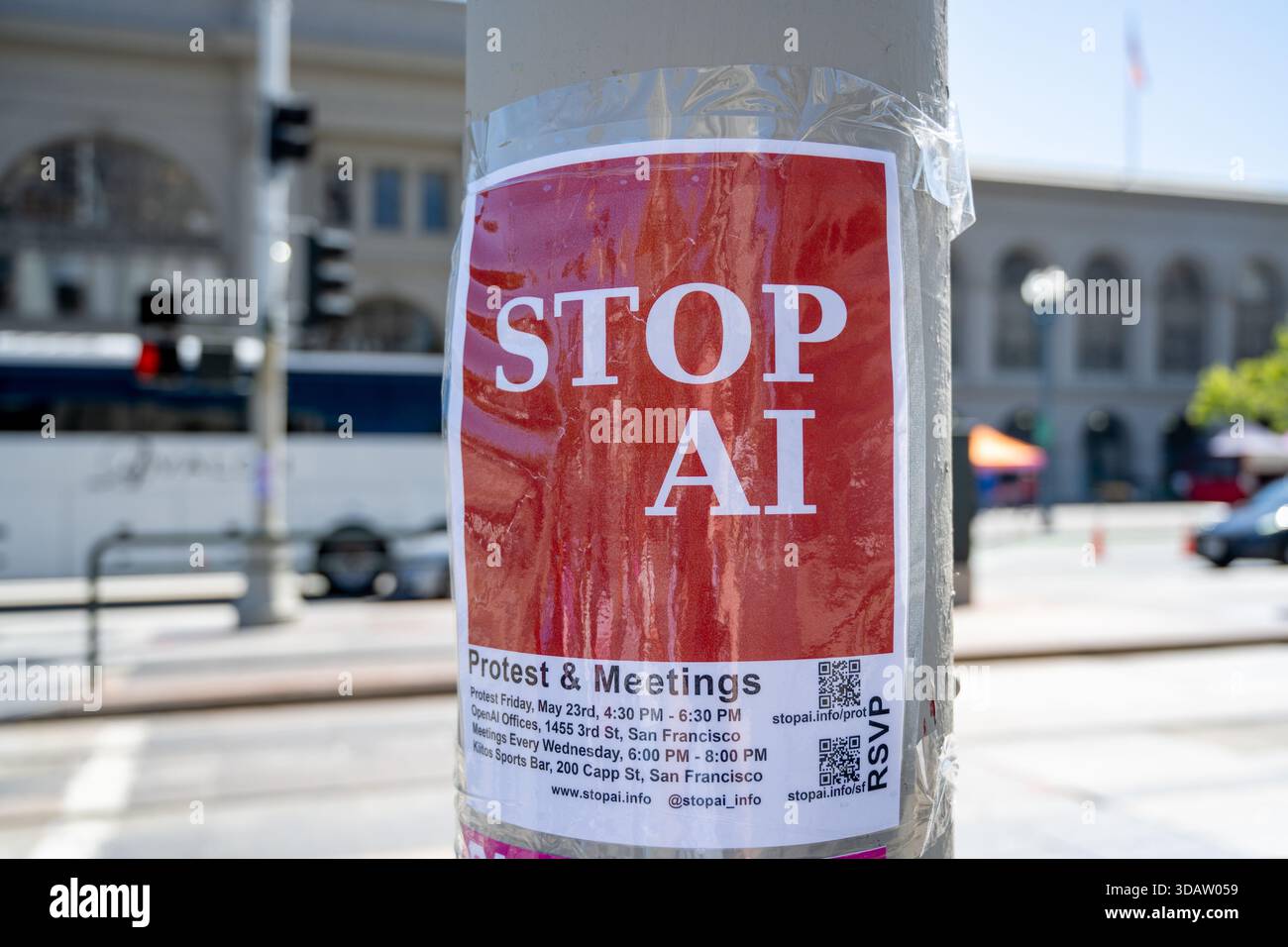 Red STOP AI protest flyer with meeting details taped to a light pole on ...