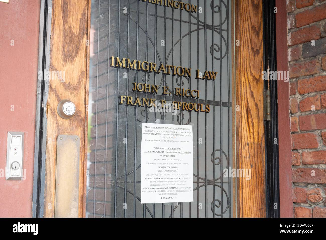 Close-up of wood and glass entrance door with gold lettering for ...