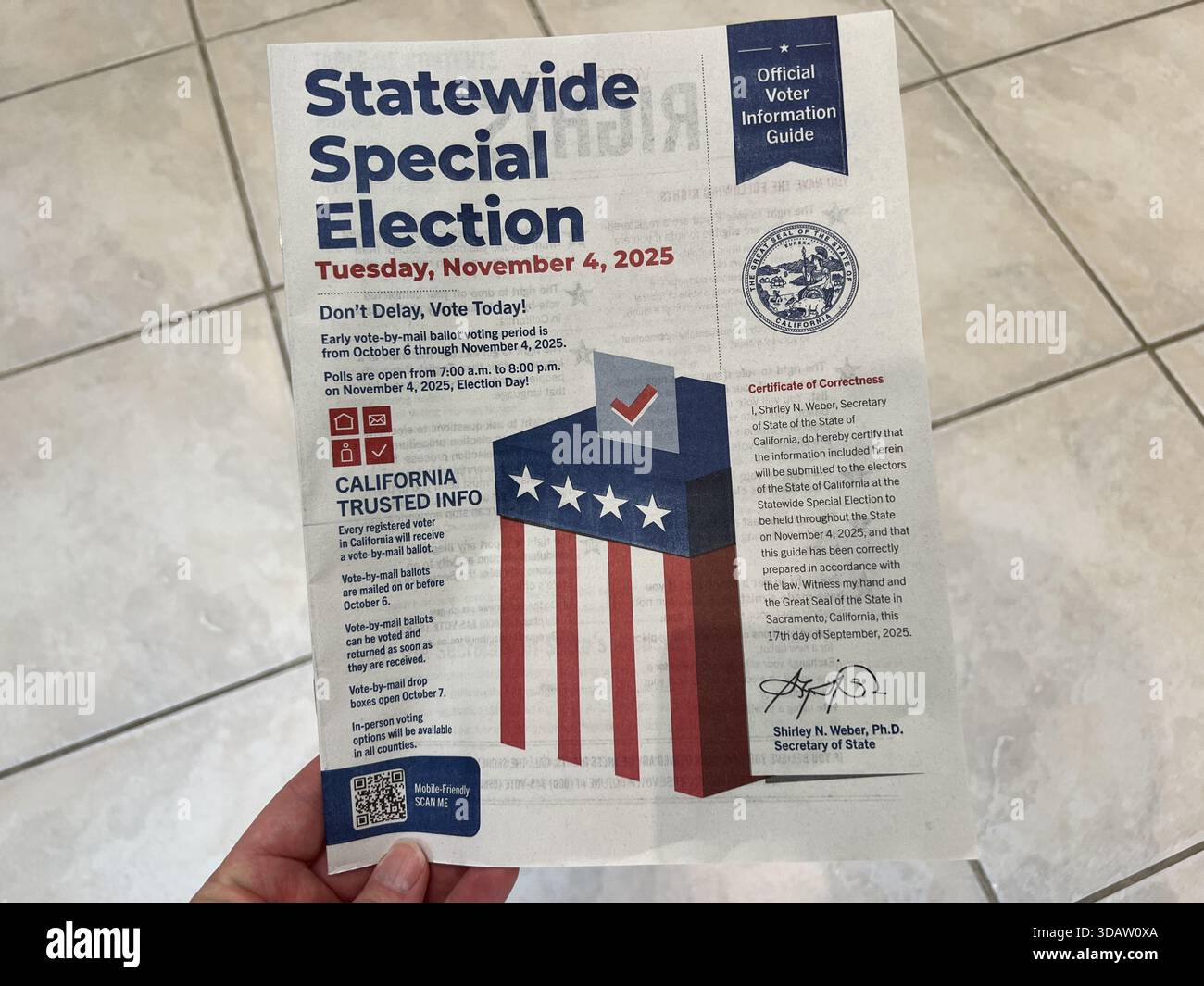 Person's hand holding voting booklet for Statewide Special Election for ...