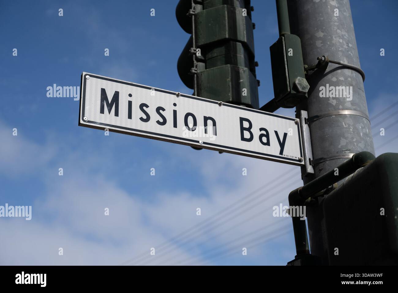 Street sign for Mission Bay neighborhood mounted on traffic signal pole ...