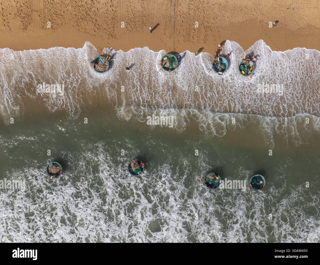 Aerial view of coracle boats resting on the sandy shore as the ...