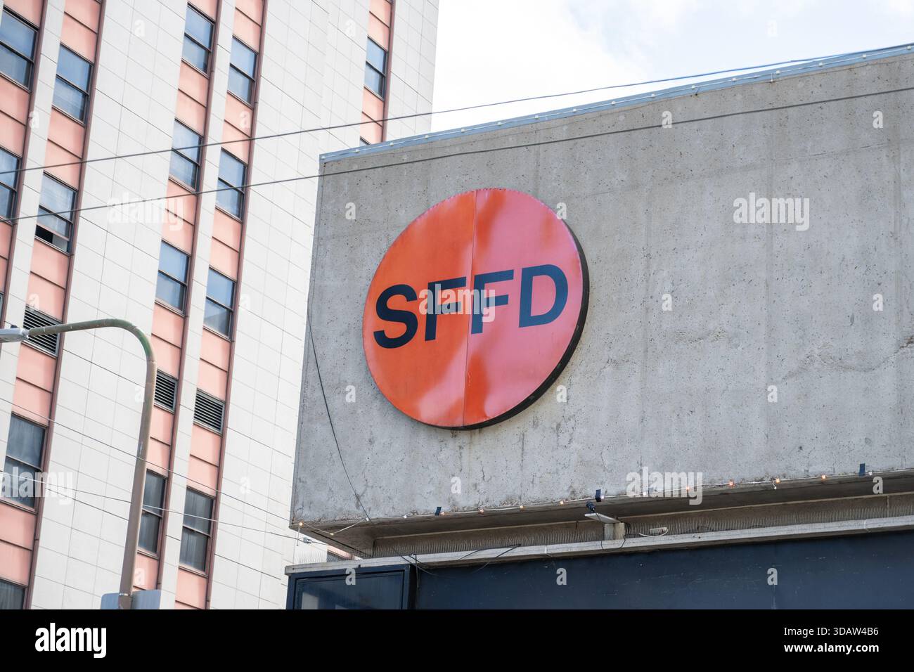 Round red SFFD (San Francisco Fire Department) emblem on concrete ...