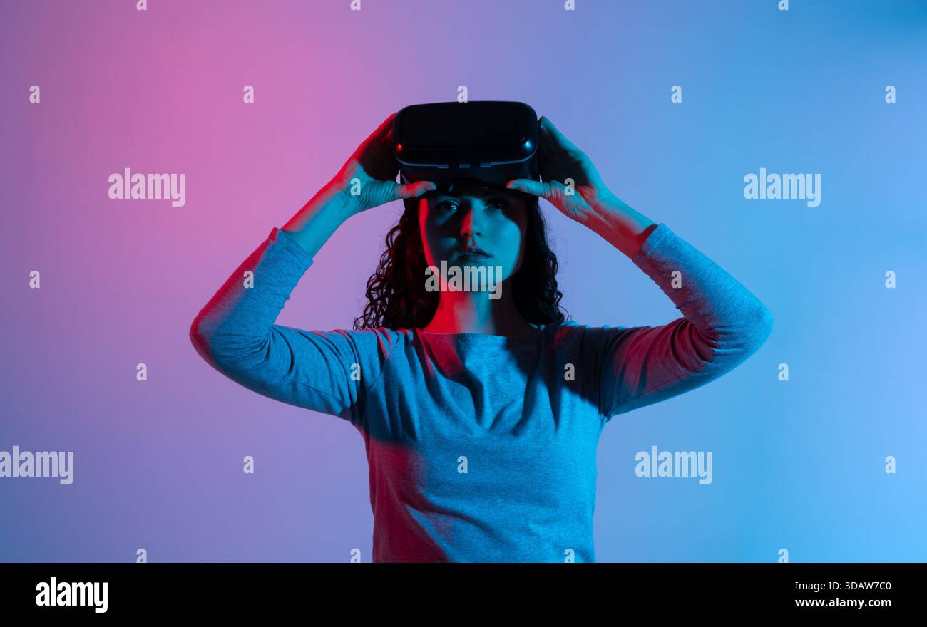 Woman lifting vr headset tech hi-res stock photography and images - Alamy