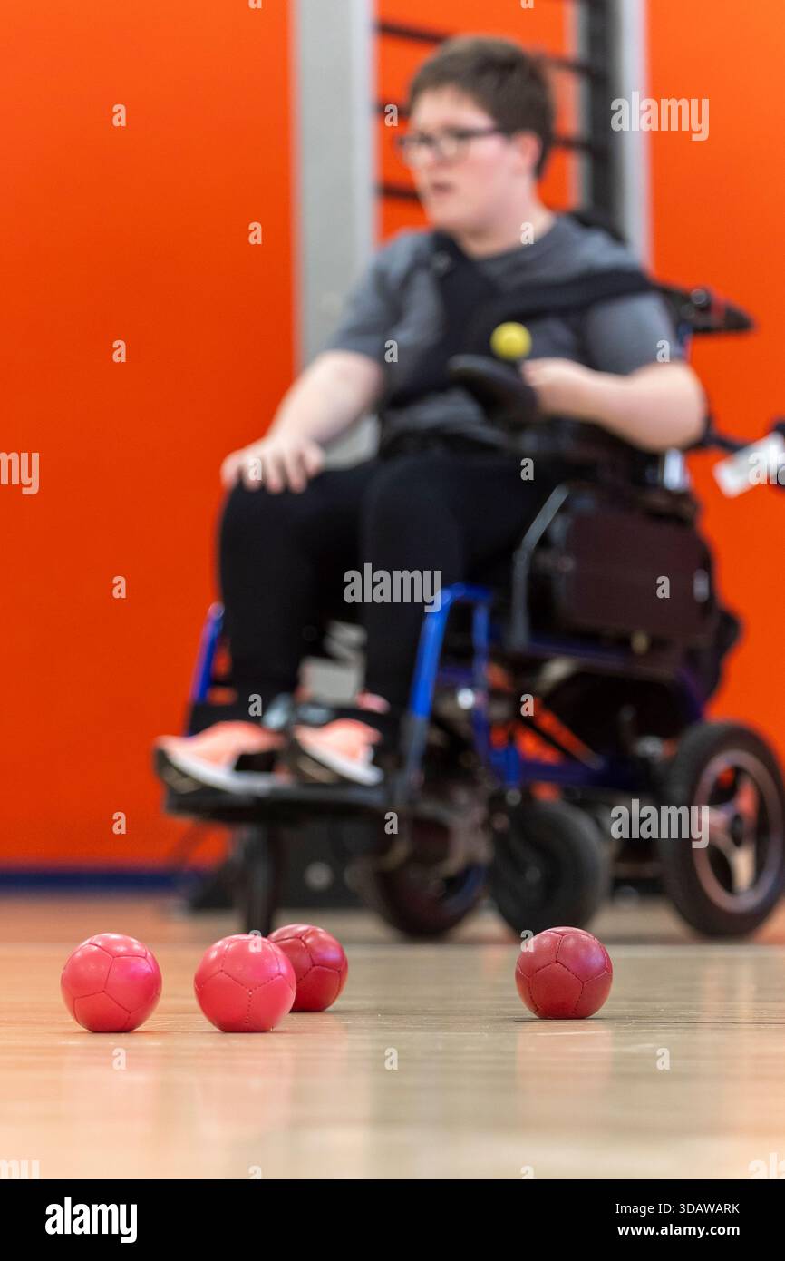 Boccia player with cerebral palsy engage in a training session. Seated ...