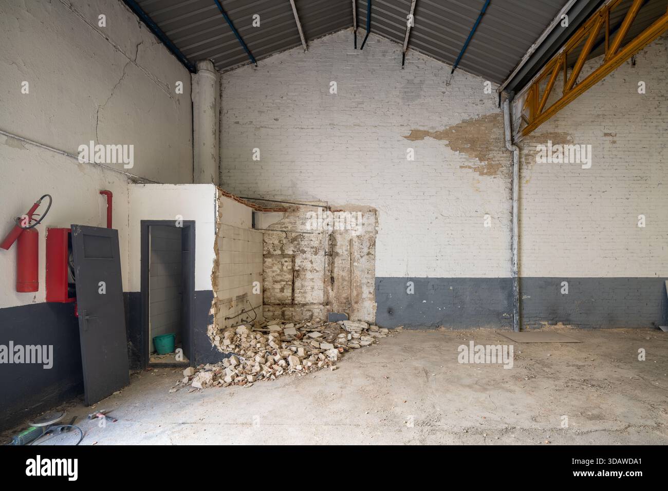 An industrial space undergoing renovation. Exposed brick walls ...