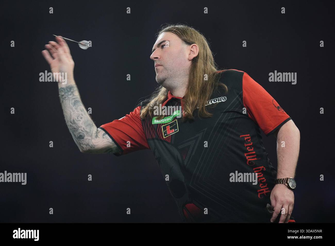 Ryan Searle of Britain throws a dart as he takes part in a round one ...