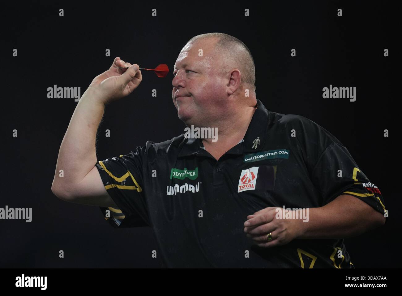 Mervyn King of Britain throws a dart as he takes part in a round one ...