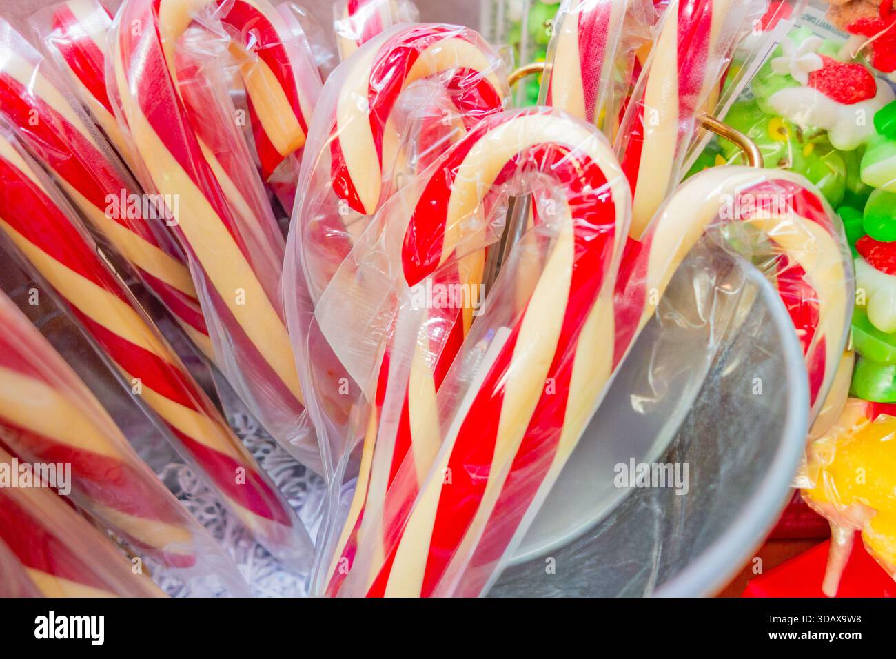 Close-up of group of brightly colored candy canes for sale at grocery ...