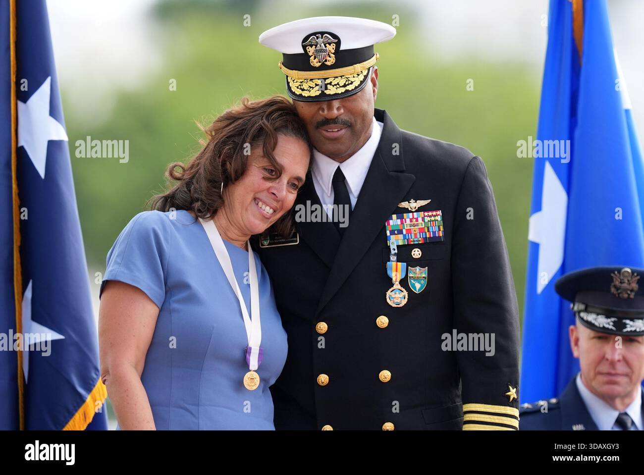 Navy Adm. Alvin Holsey, center, embraces his wife Stephanie as she is ...