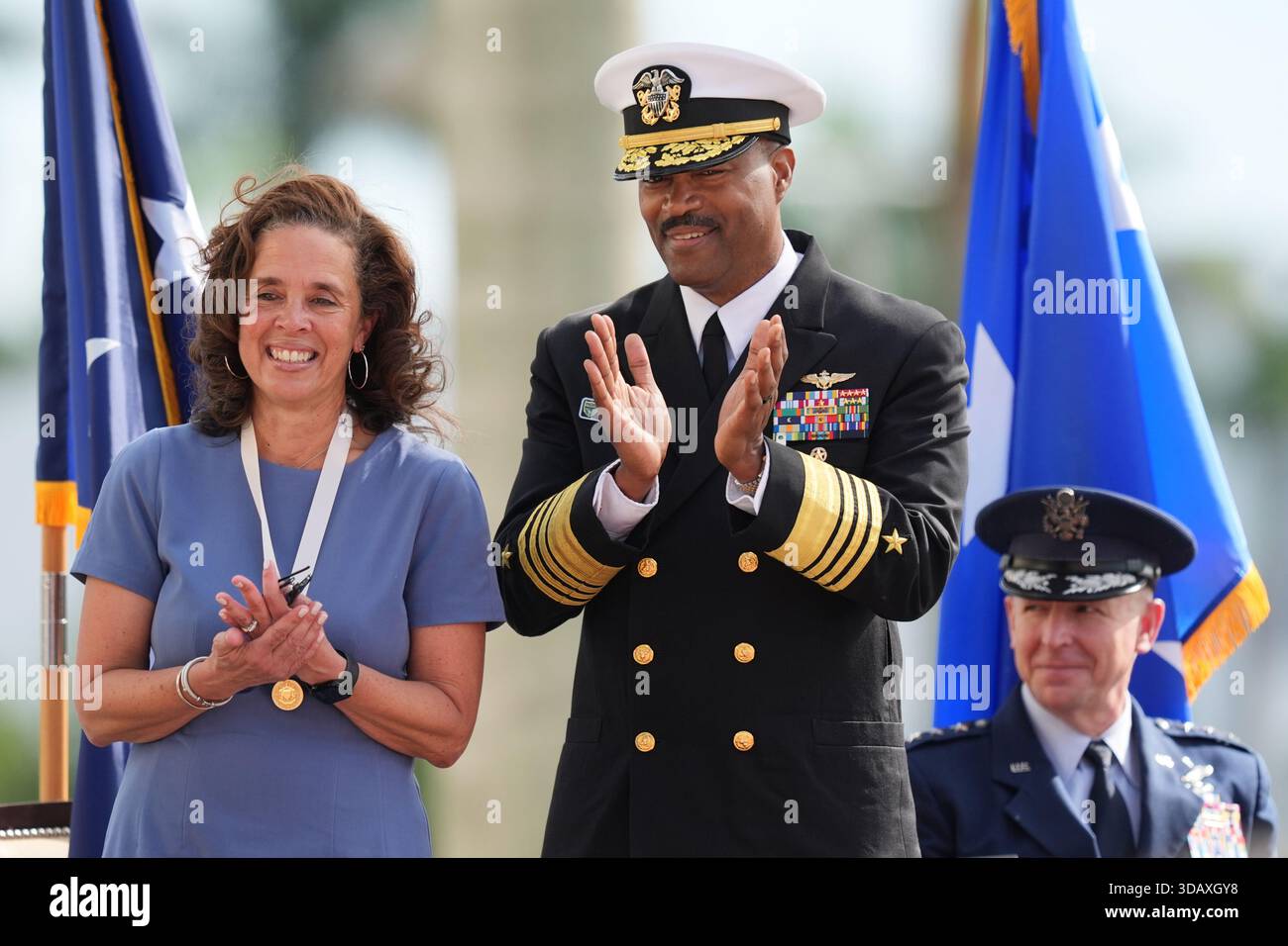Navy Adm. Alvin Holsey, center, applauds as his wife Stephanie is ...