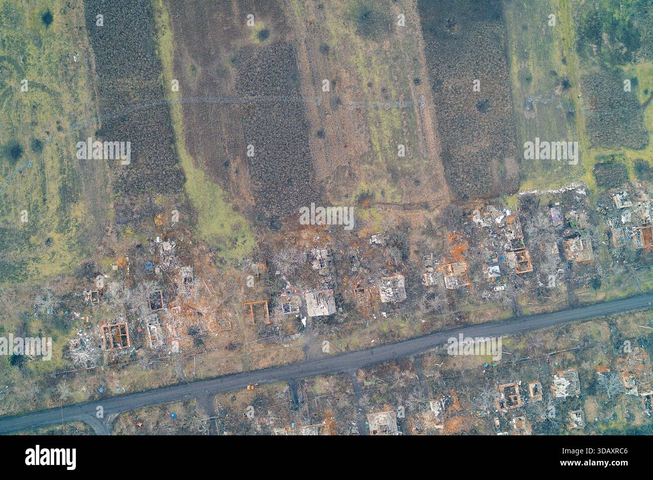 Top-down view of a heavily destroyed residential area featuring ruins ...