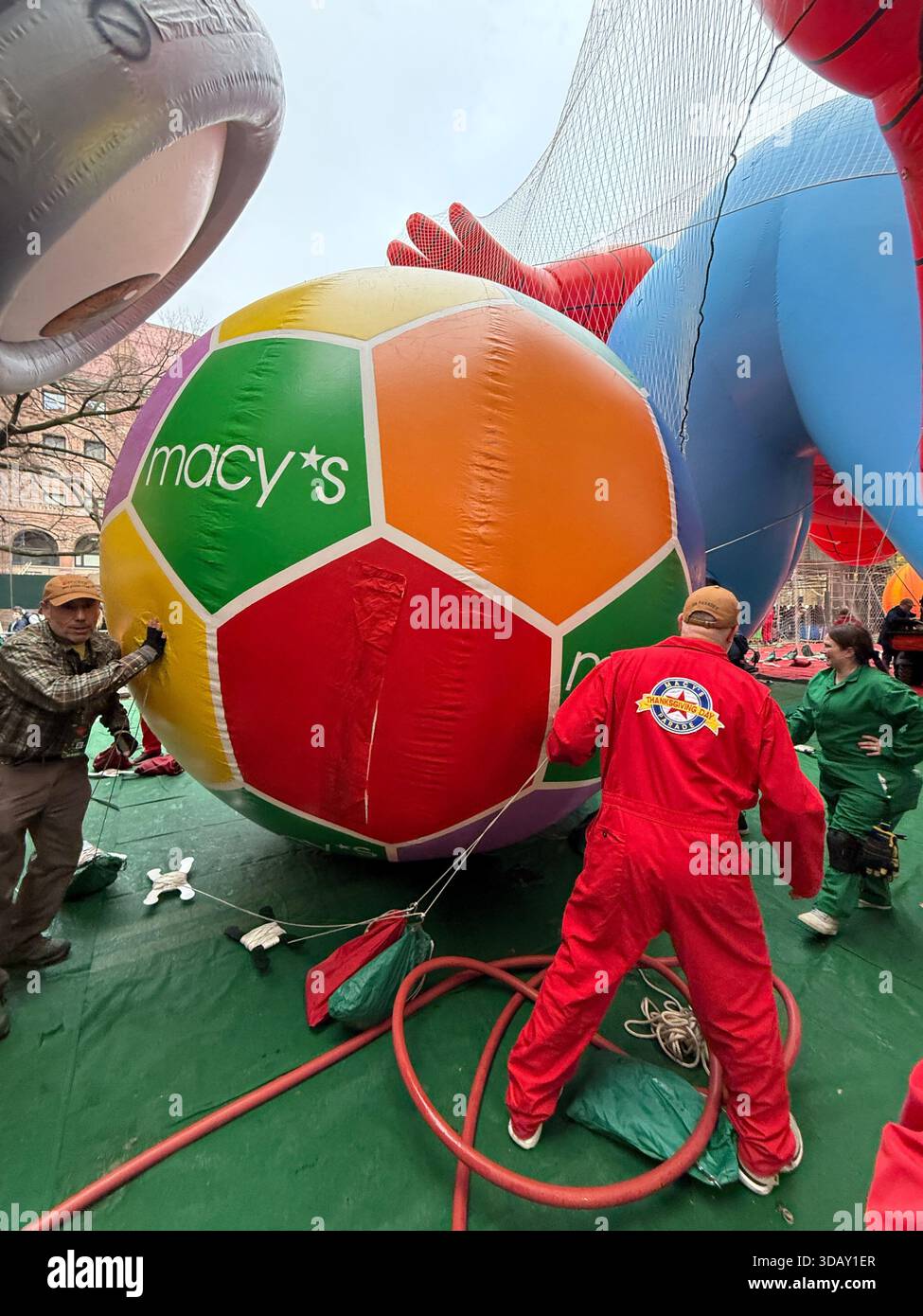 Inflating the large balloon cartoon characters along Central Park West ...