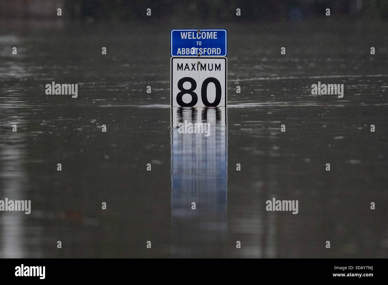 A Highway 1 speed limit sign pokes out from the floodwaters in ...