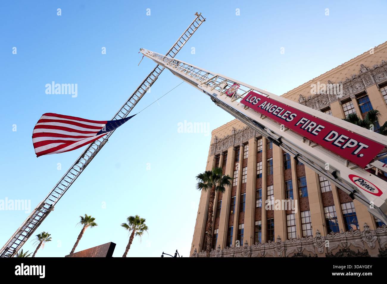 Fire truck ladders are pictured outside a ceremony to honor the Los ...