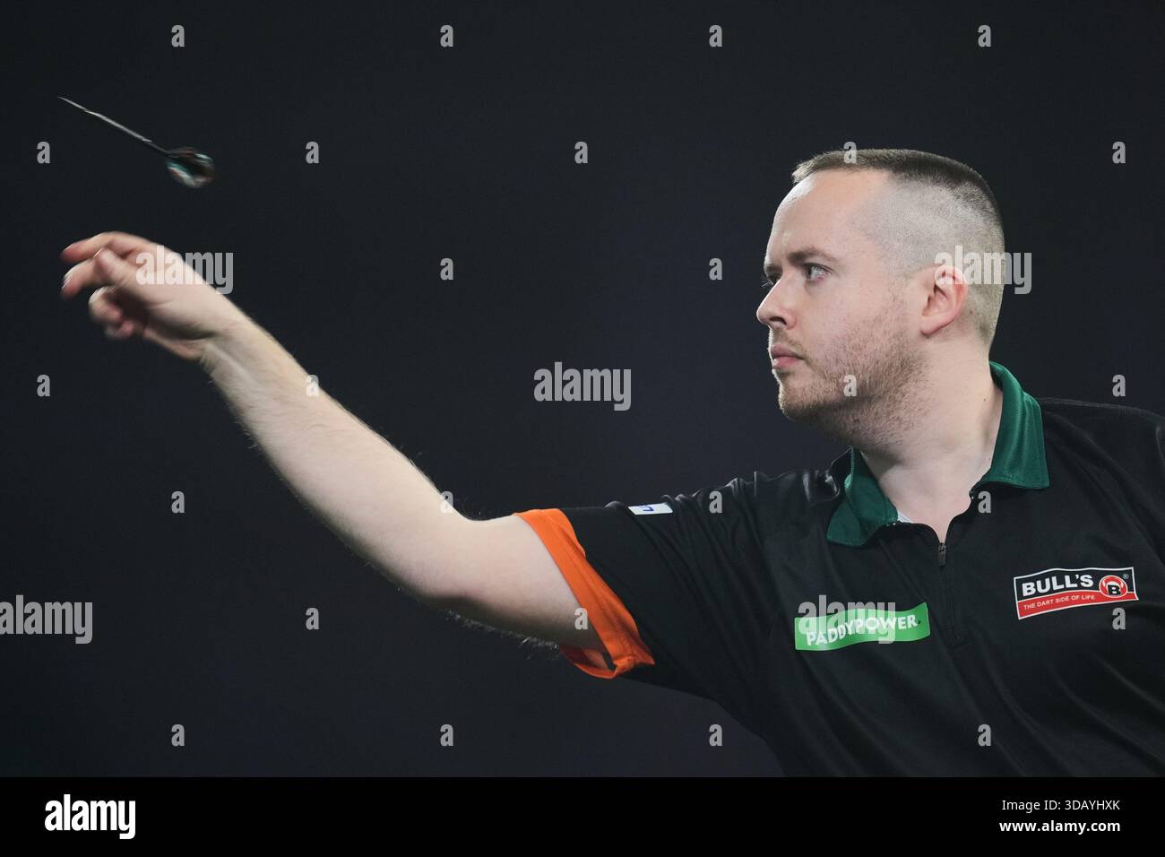 Steve Lennon, of Ireland, throws a dart as he takes part in a round one ...