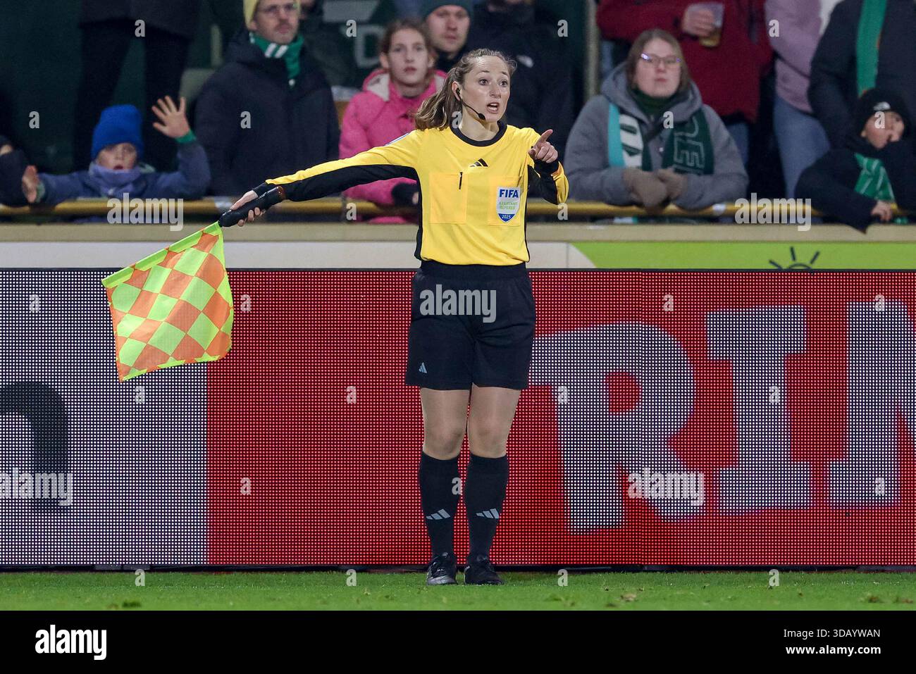 Referee assistant Melissa Joos signals a corner kick, gives a flag ...