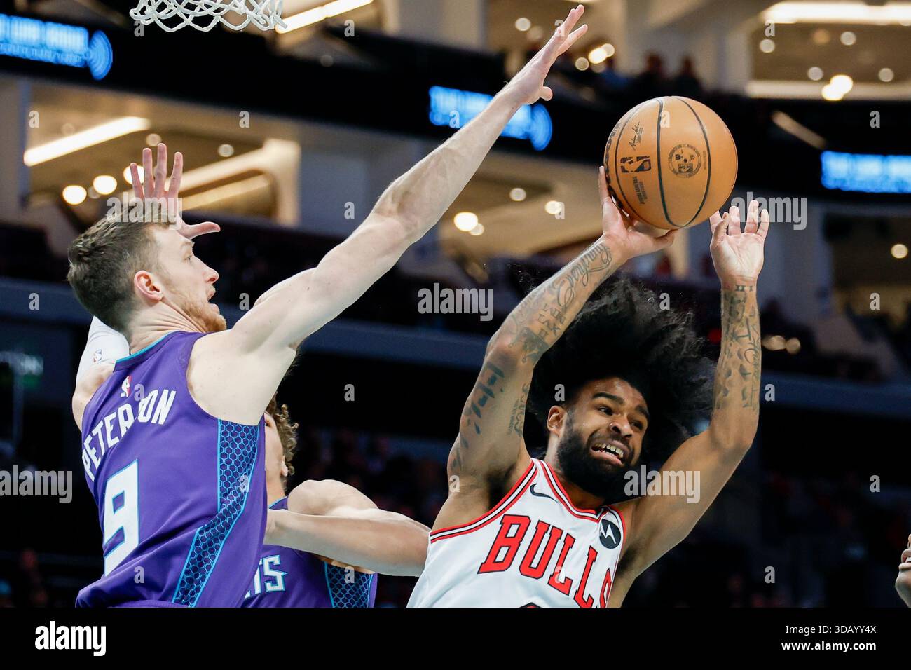 Chicago Bulls guard Coby White, right, looks to pass the ball against ...