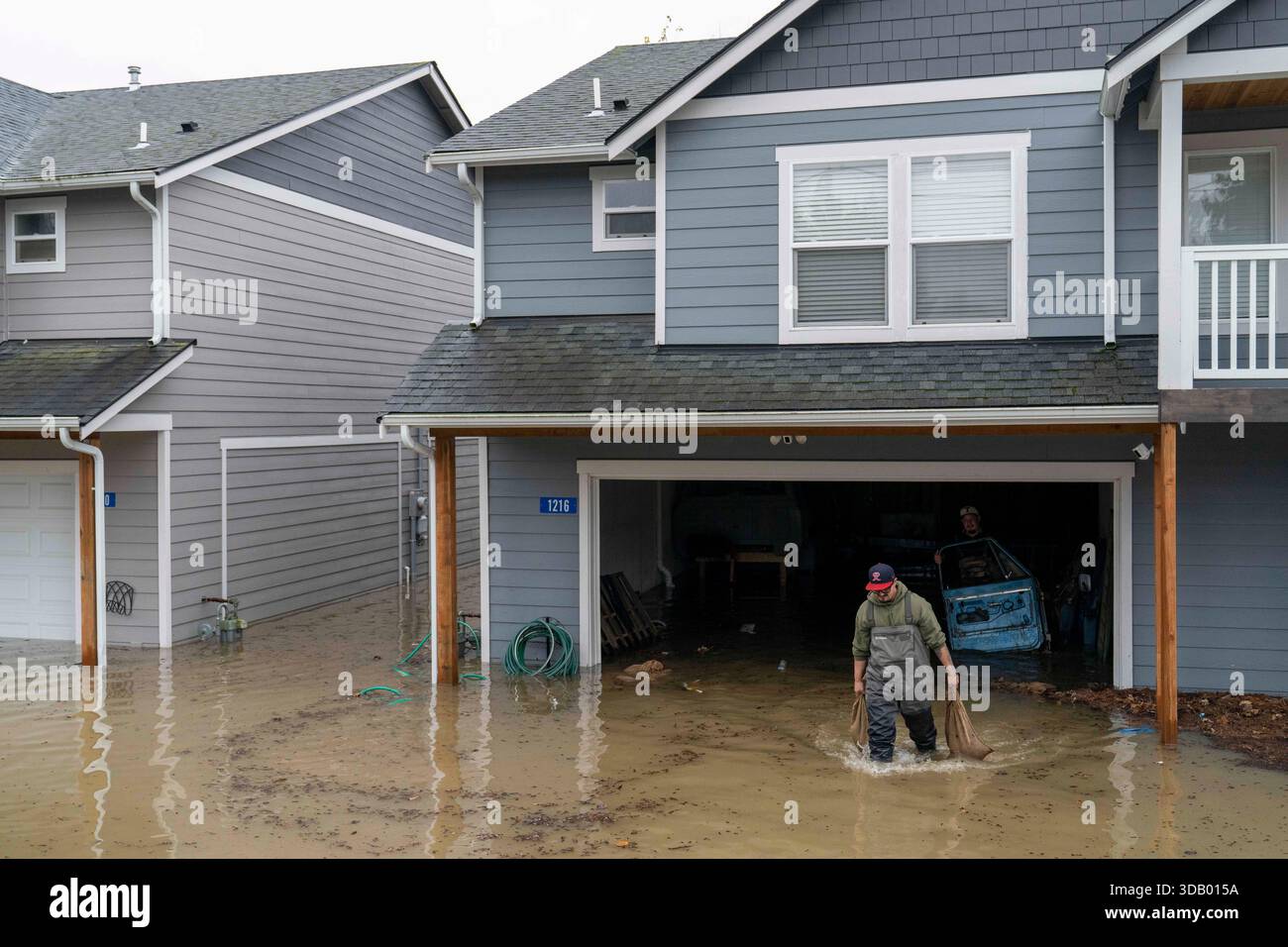 December 12, 2025, Burlington, Washington, USA: Rafa Castro helps clear ...