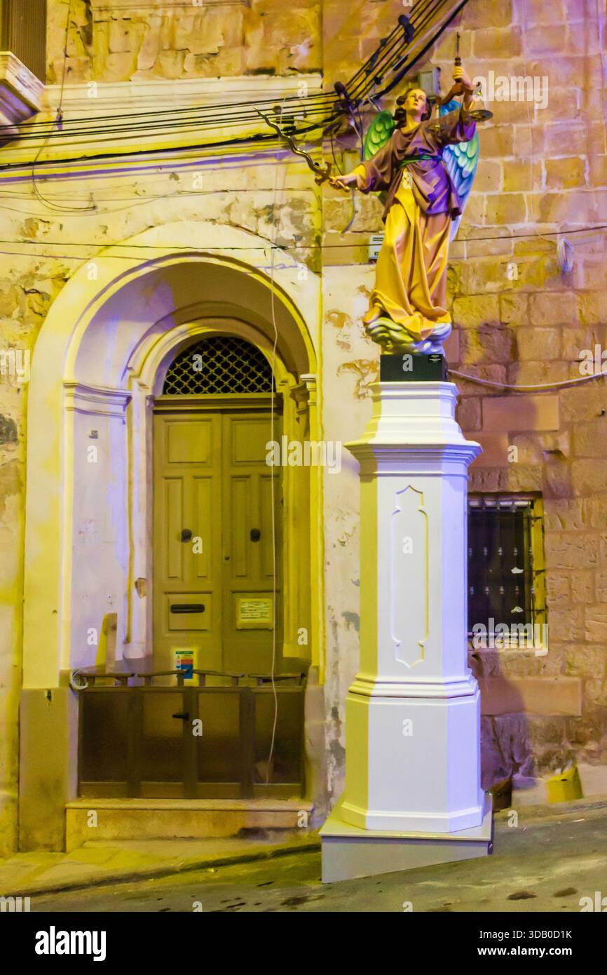 Angel Statue on White Pedestal Beside Historic Arch Doorway Under Night ...