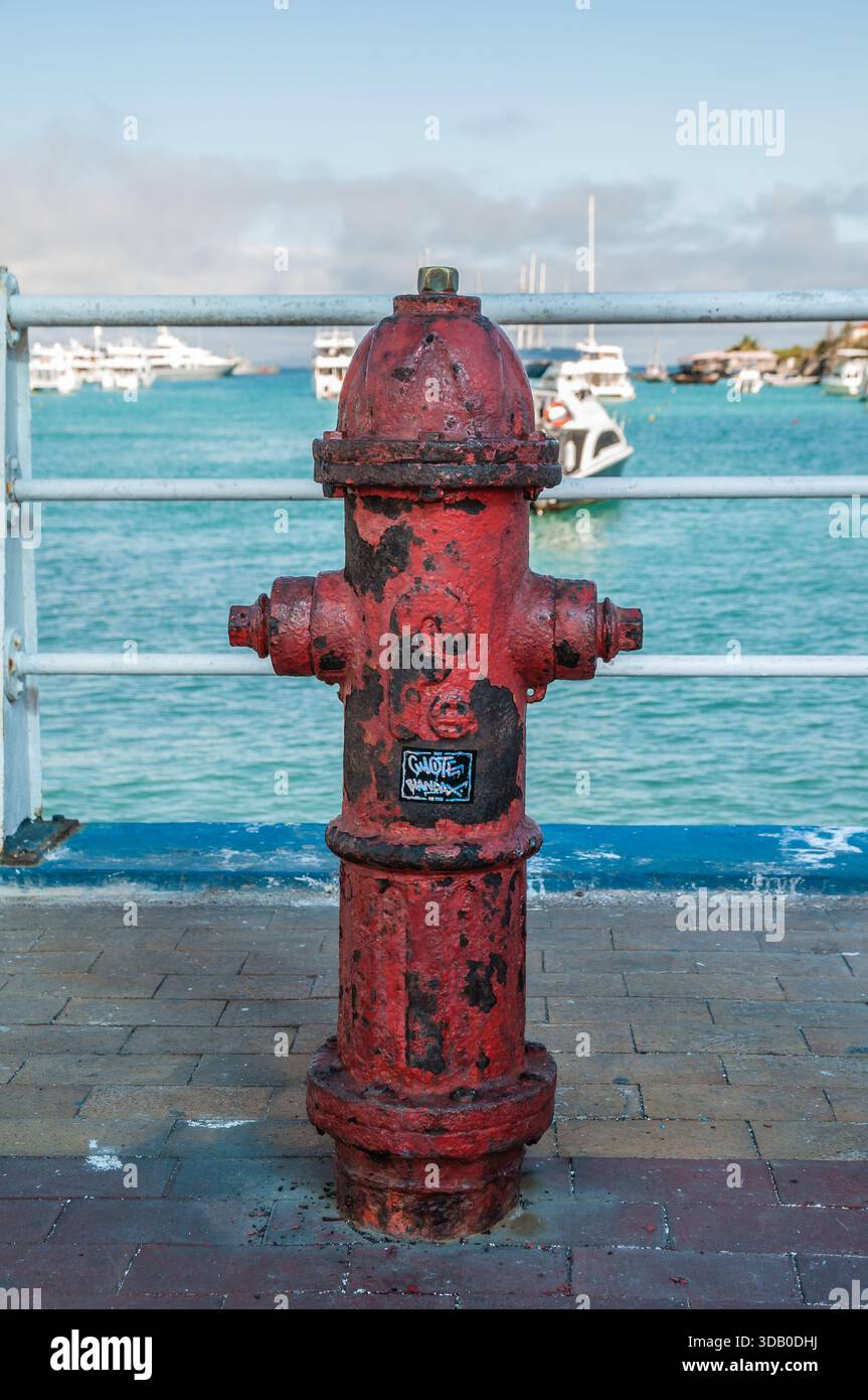 red column hydrant on the dock, old, rusty, Puerto Ayora, Santa Cruz ...