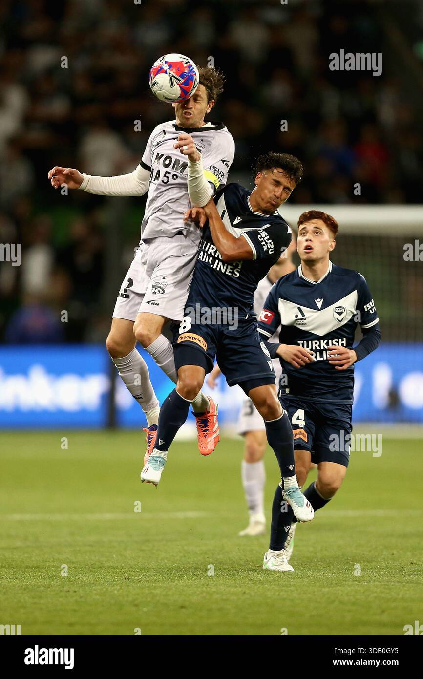 Craig Goodwin of United and Jordi Valadon of Victory contest the ball ...