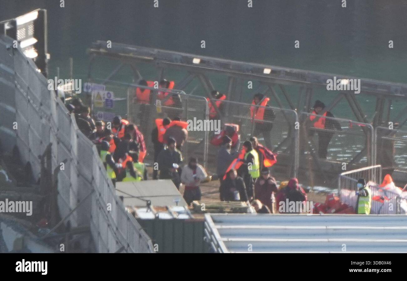 A group of people thought to be migrants are brought in to the Border ...