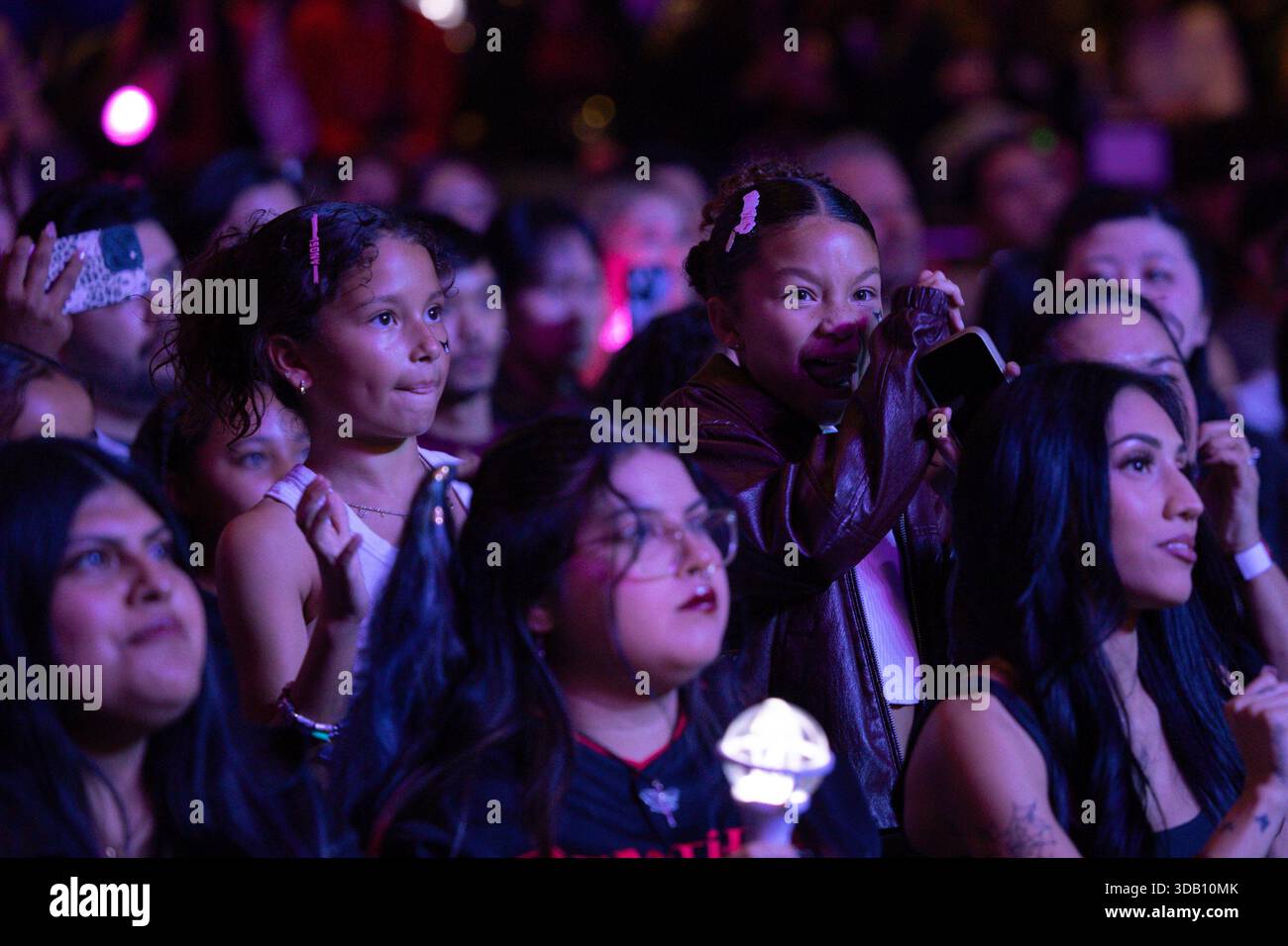Concertgoers dance as the group KATSEYE performs on Friday, Dec. 12 ...