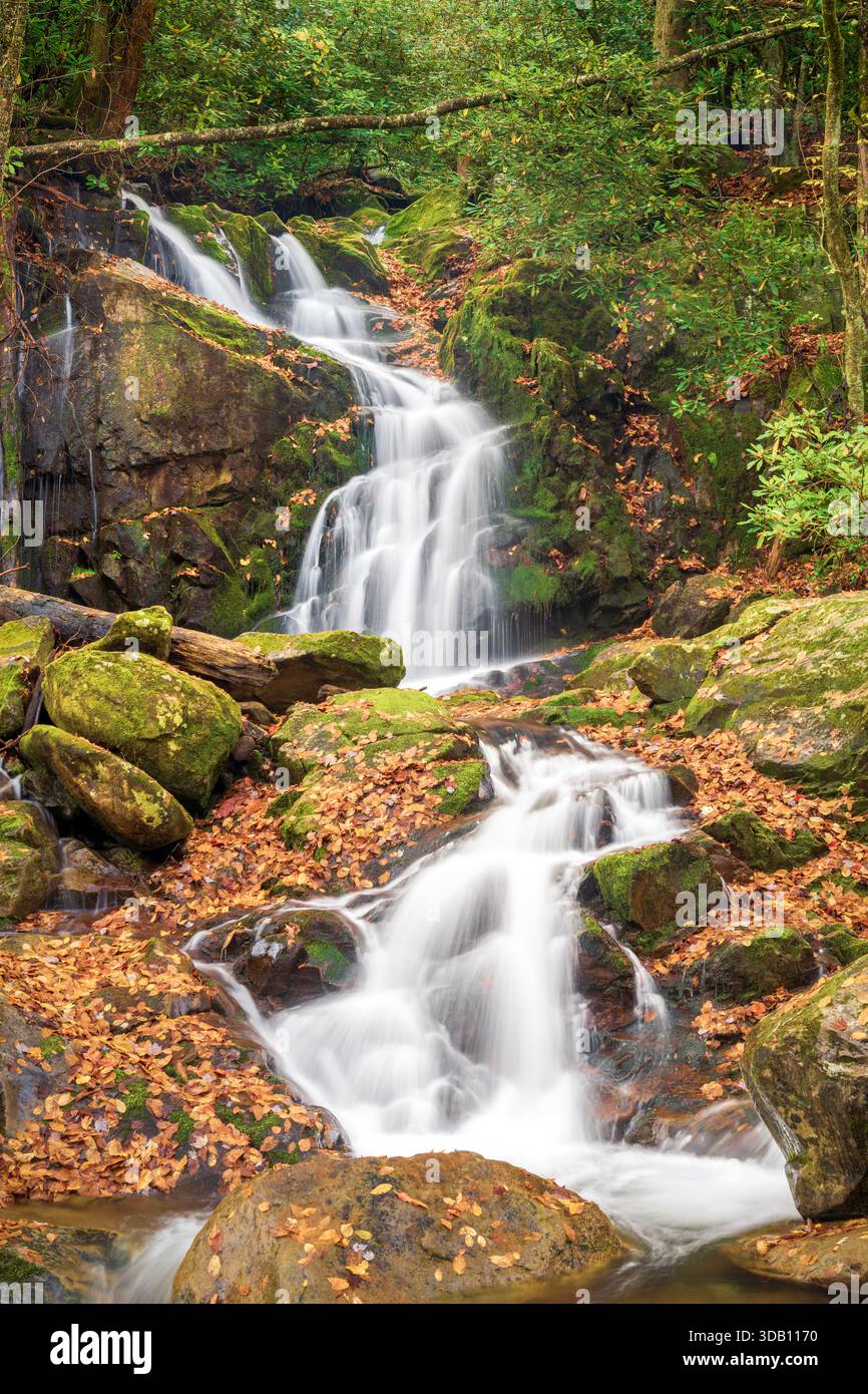 A large 100 foot waterfall in the Smoky Mountains shows the ruggedness ...